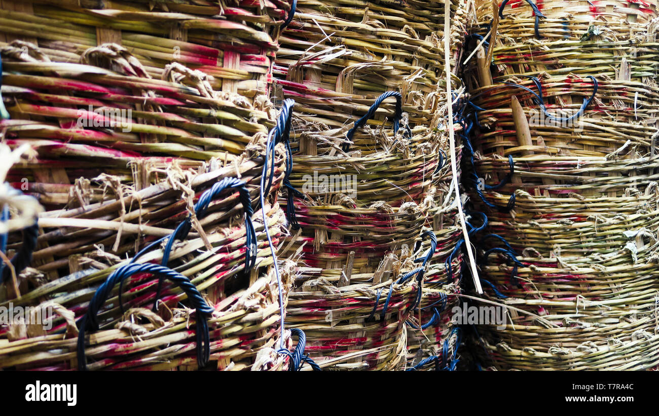 Stack of big wicker baskets in market Stock Photo - Alamy