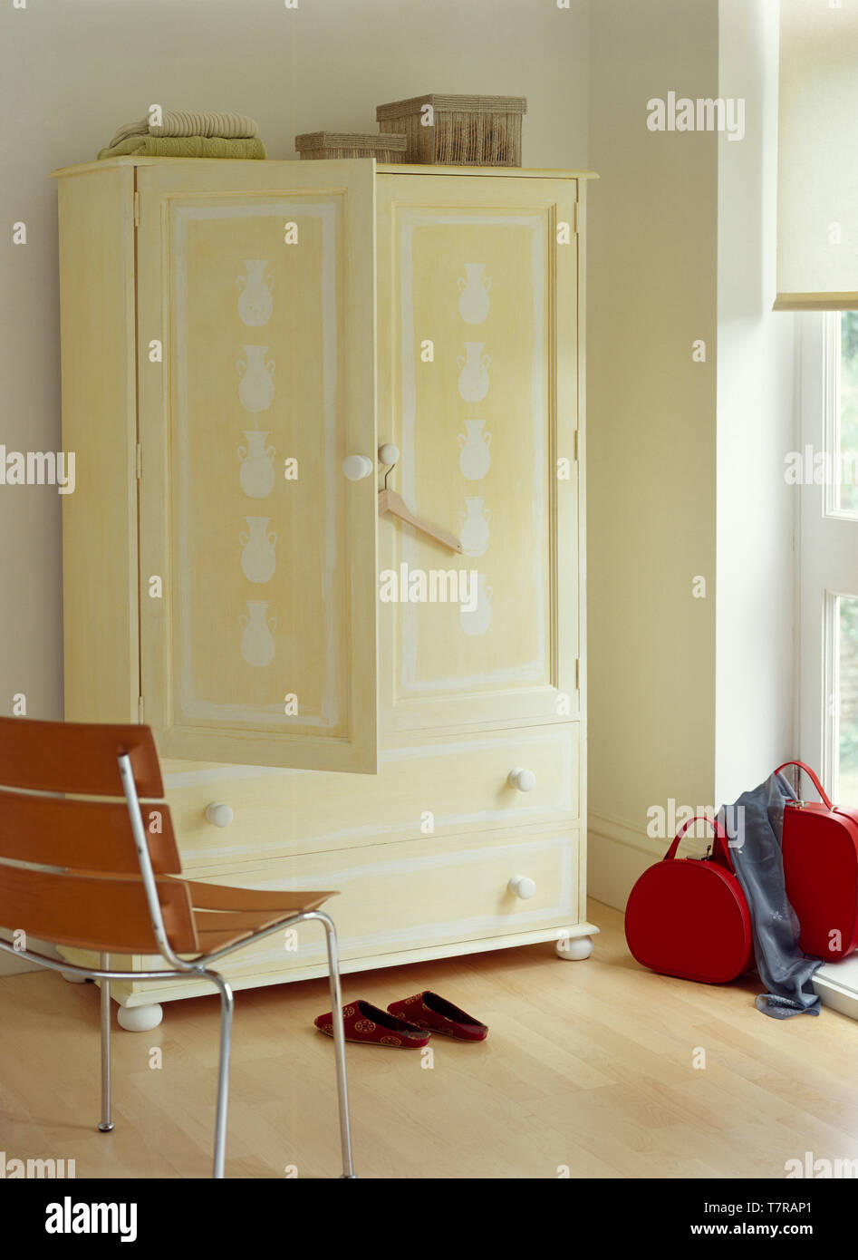 Stenciled pale yellow wardrobe in townhouse bedroom Stock Photo - Alamy