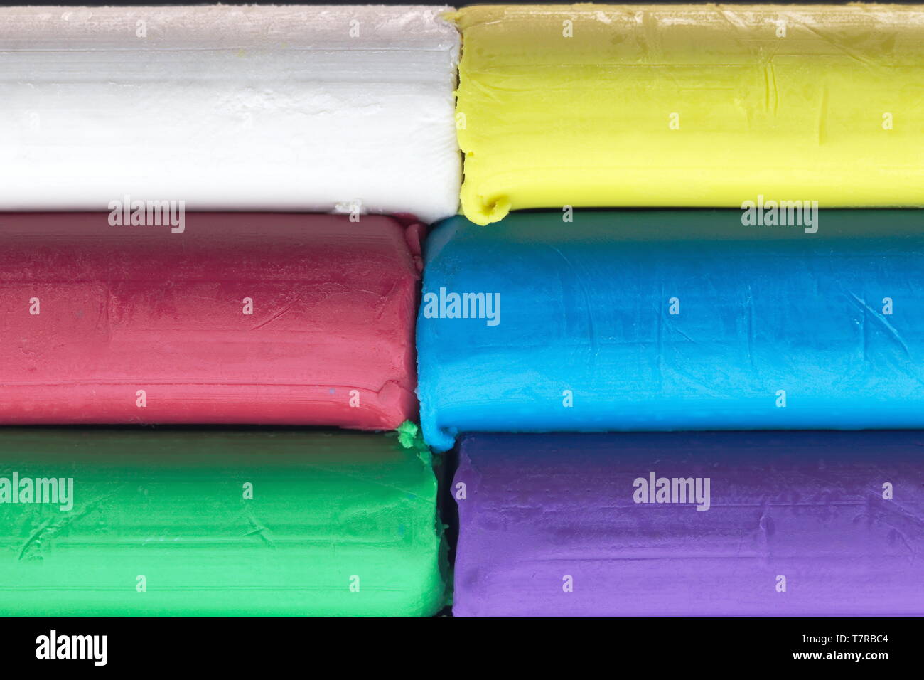 A stack of modeling clay with various colourful colors in white, yellow ...