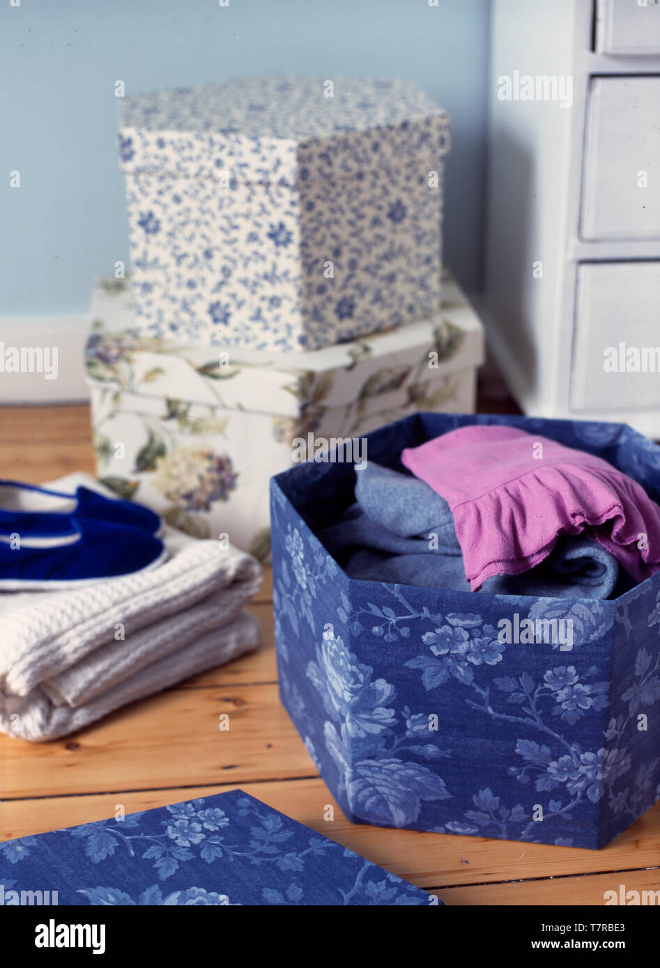 Storage boxes covered with decorative wallpaper Stock Photo - Alamy