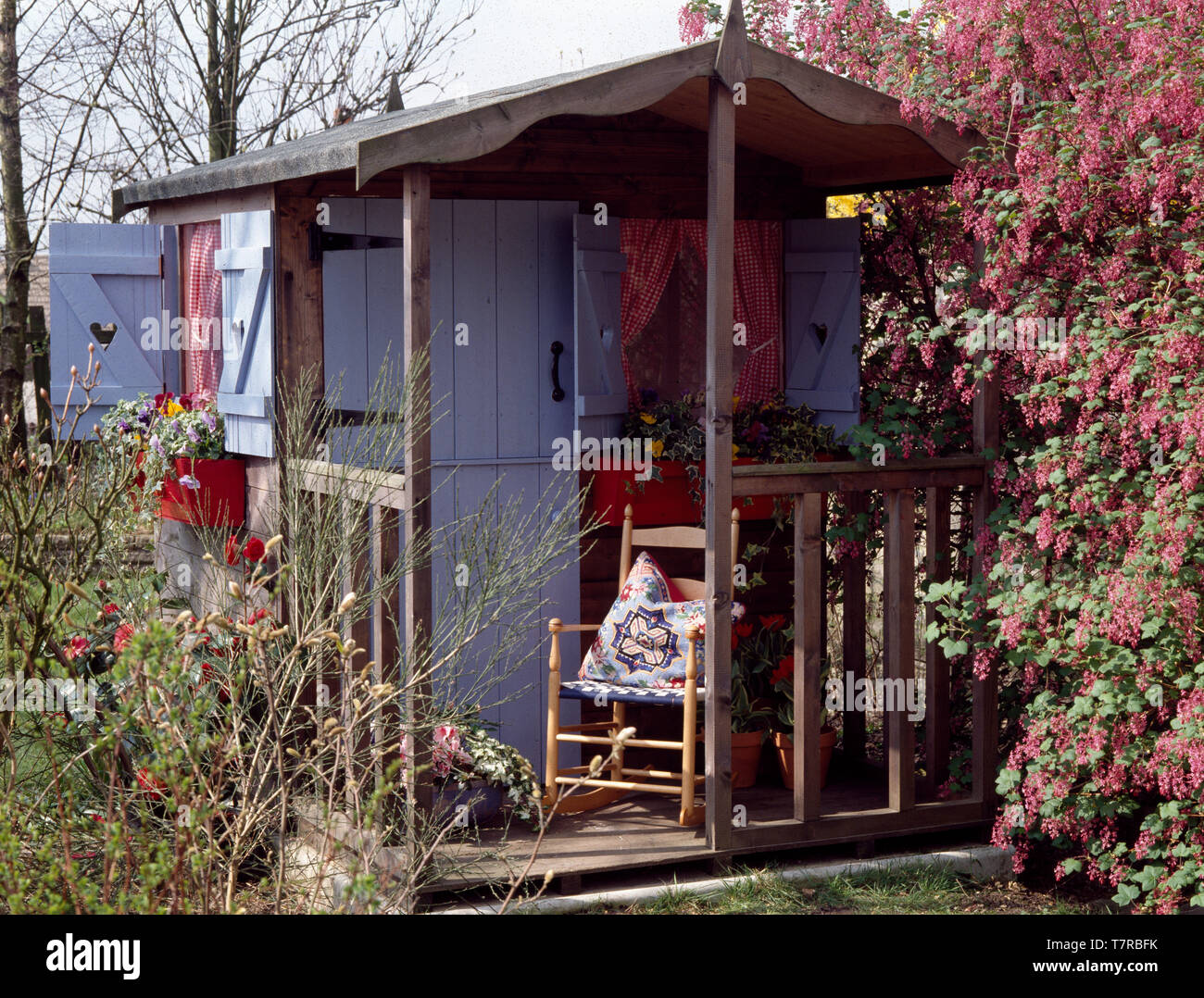 Pale blue painted wooden summer house with veranda Stock Photo - Alamy