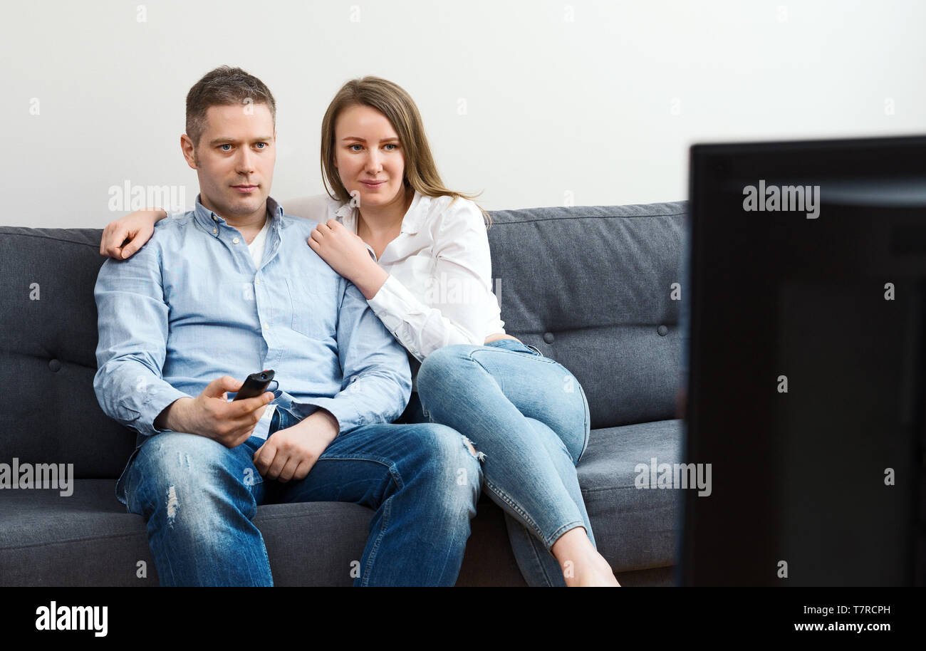 Man and woman watching TV at home Stock Photo - Alamy