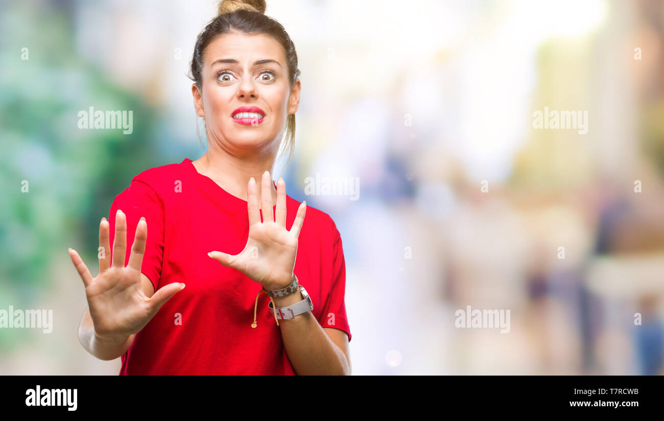 Young beautiful woman over isolated background afraid and terrified ...