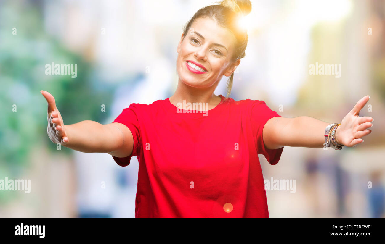 Young beautiful woman over isolated background looking at the camera ...
