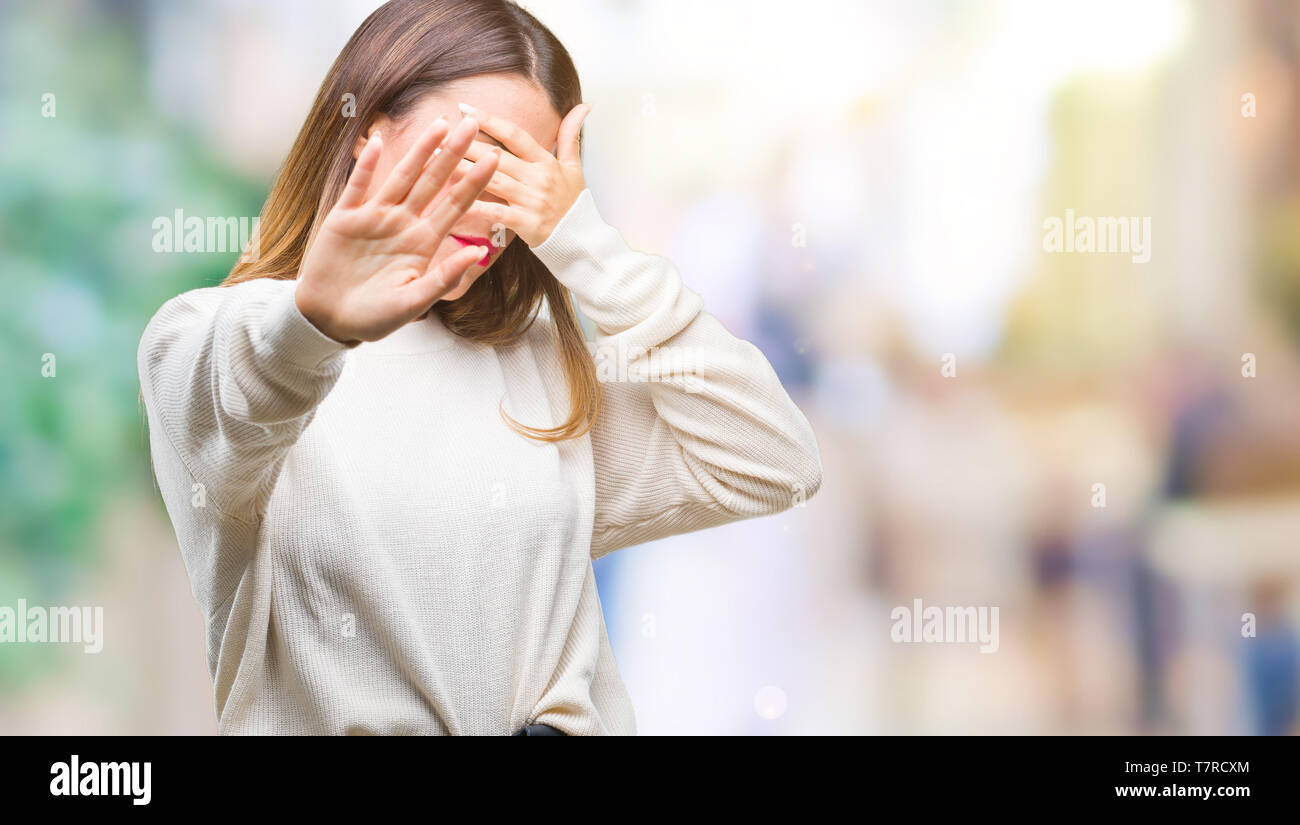 Young beautiful woman casual white sweater over isolated background ...