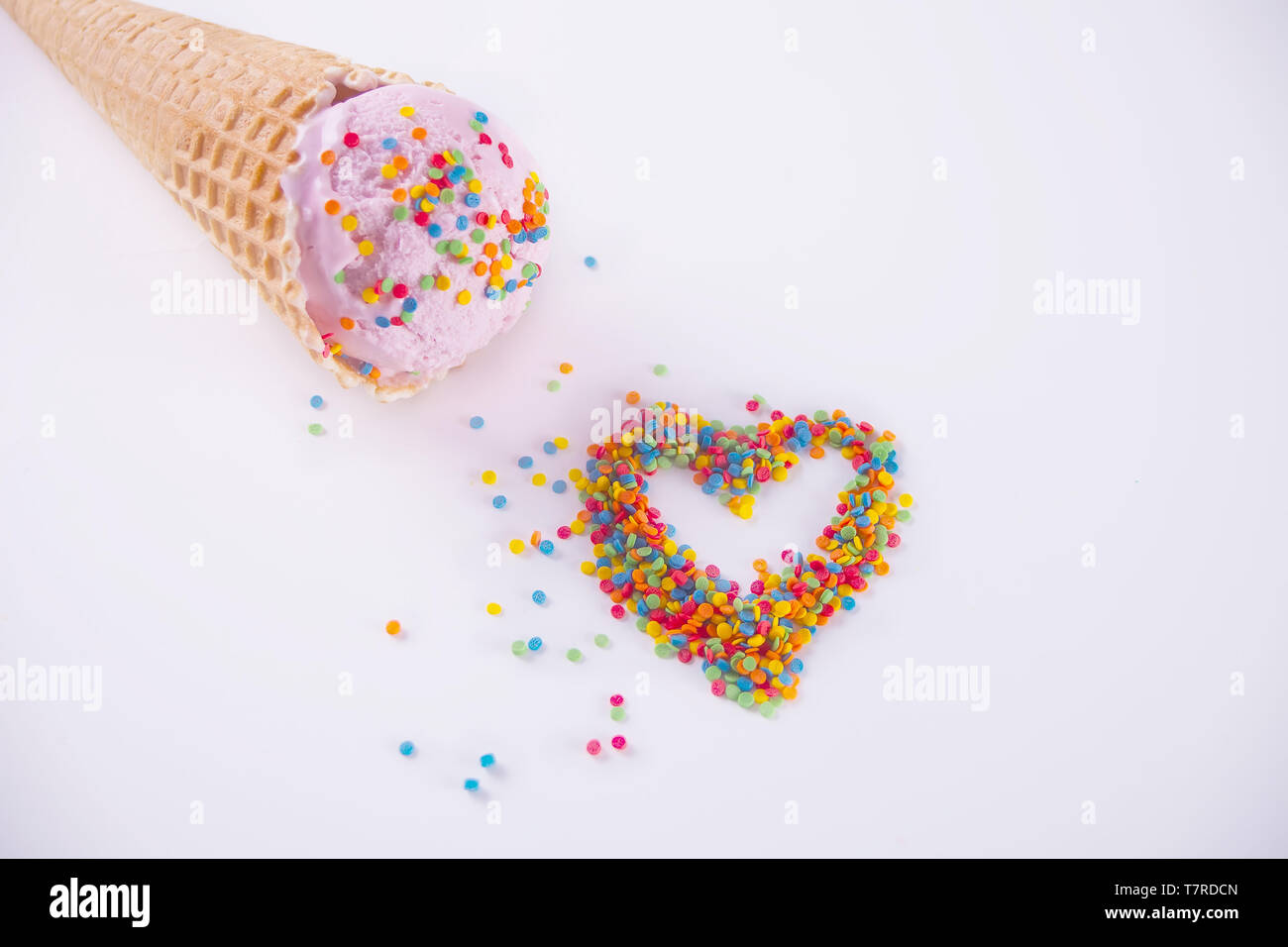 Colorful candies in the shape of a heart and ice cream cone on the ...