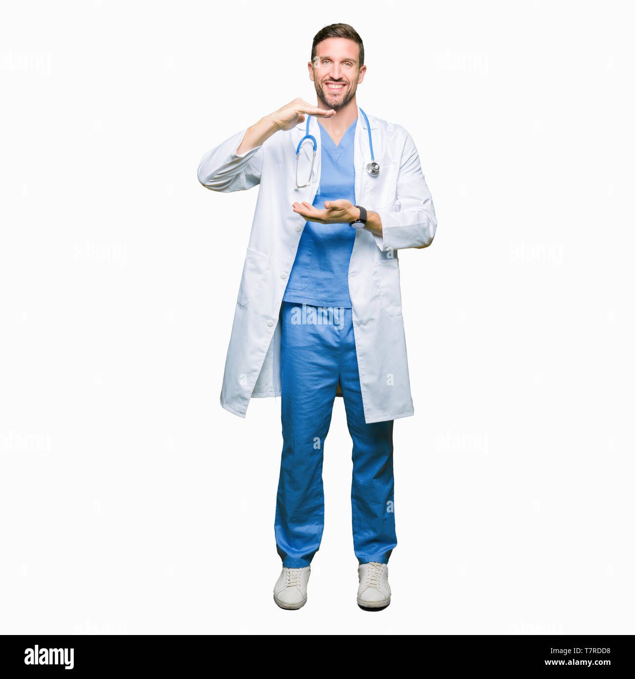 Handsome doctor man wearing medical uniform over isolated background ...