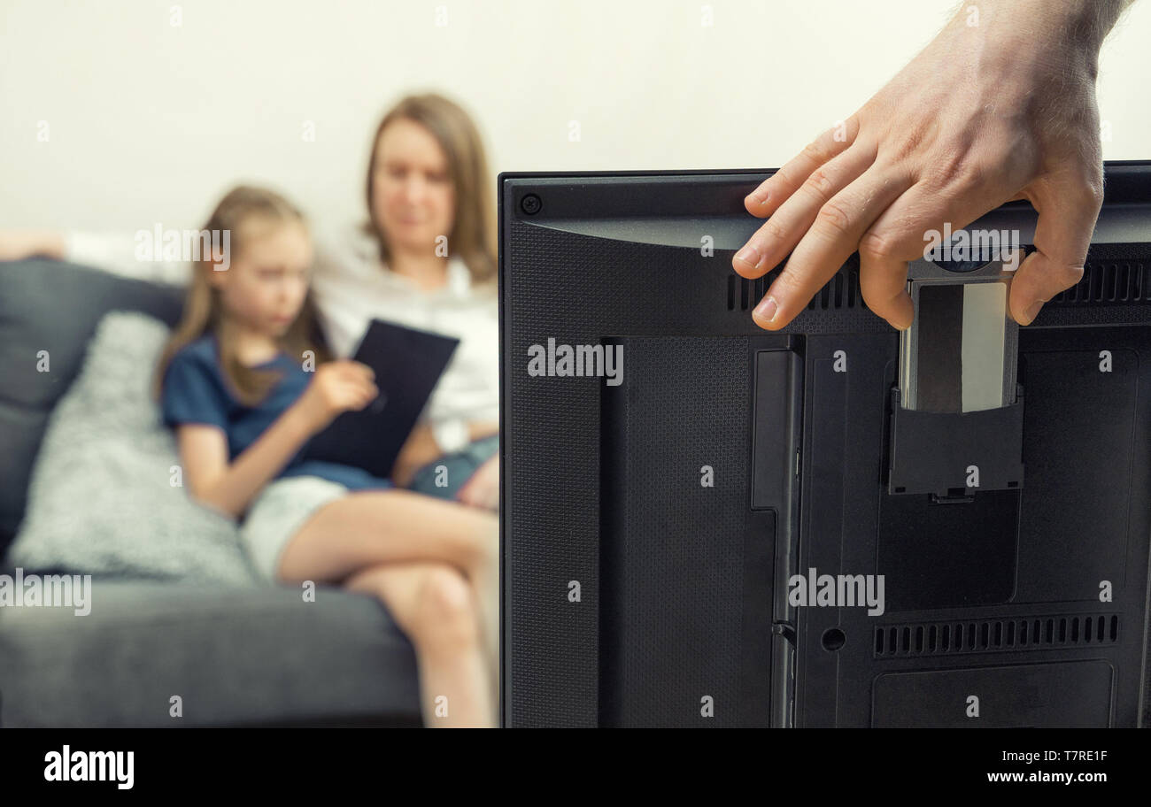 Man installing conditional access module card to TV Stock Photo - Alamy