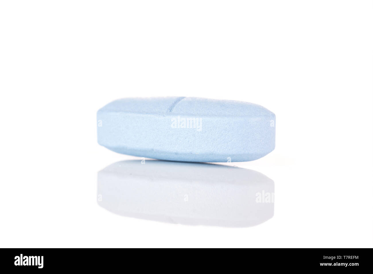 One whole blue medical drug isolated on white background Stock Photo ...