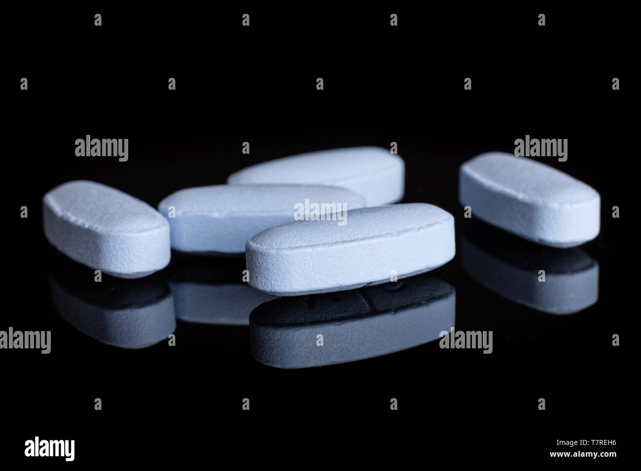 Group of five whole blue medical drug isolated on black glass Stock ...