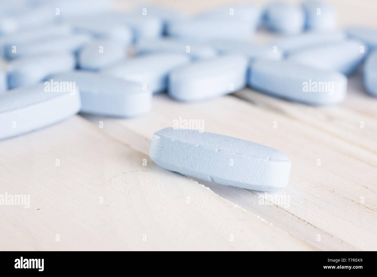 Lot of whole blue medical drug on white wood Stock Photo - Alamy