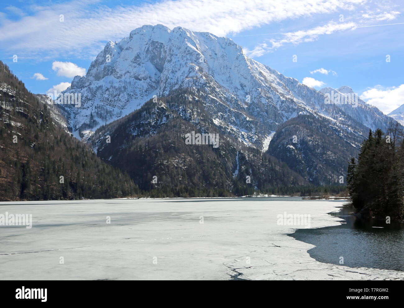 landscape of frozen alpine lake in Northern Italy called Lago Predil n ...