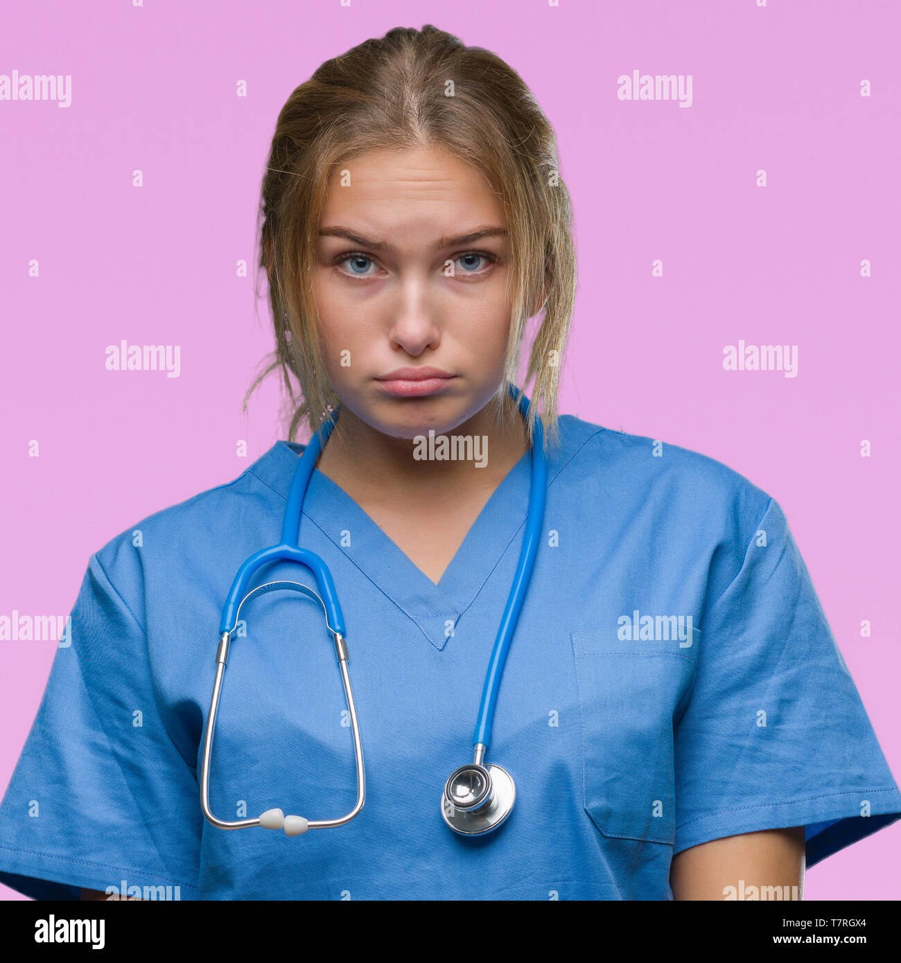 Young caucasian doctor woman wearing surgeon uniform over isolated ...