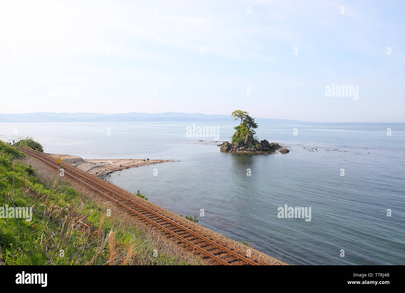 Amaharashi beach with small island and train rail Toyama Japan Stock ...