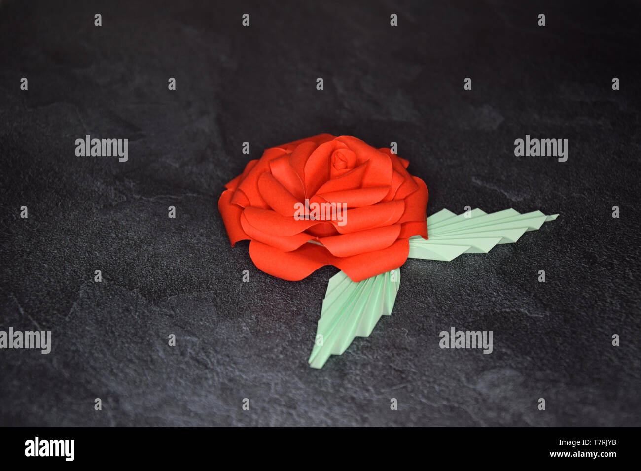 Red Origami Rose Blossom - Paper Art on Textured Background Stock Photo ...