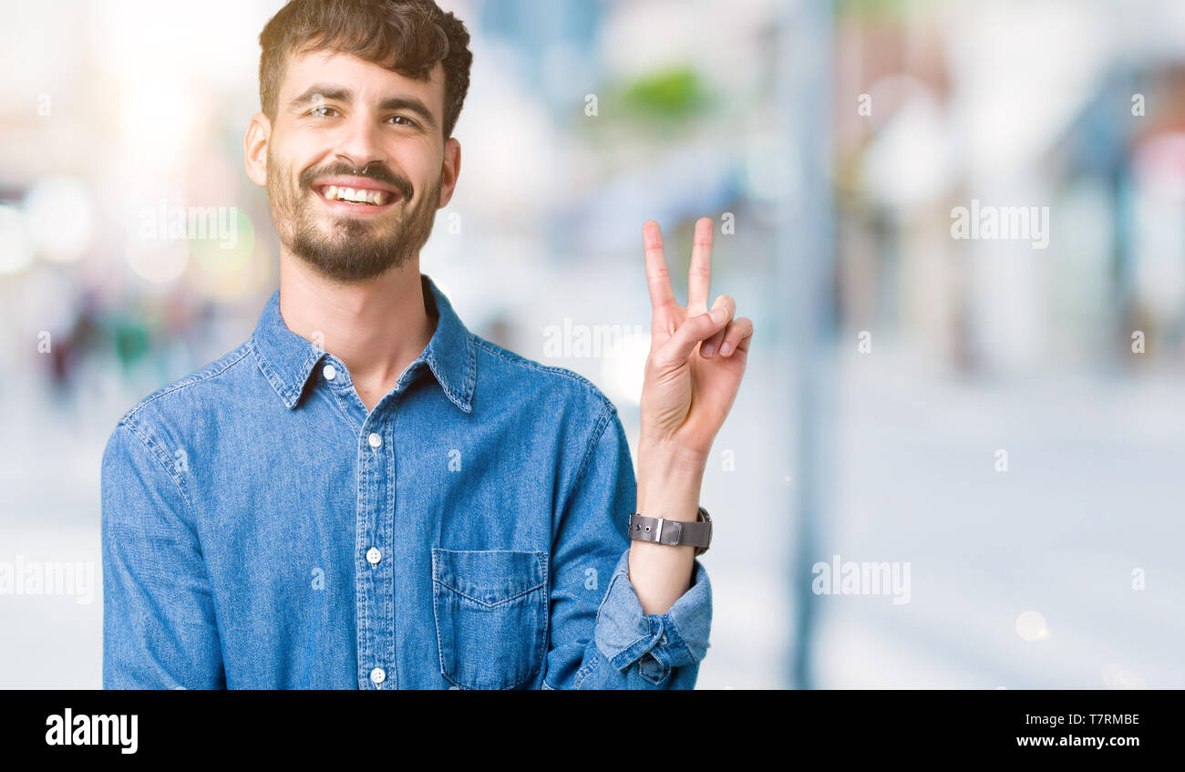 Young handsome man over isolated background smiling with happy face ...