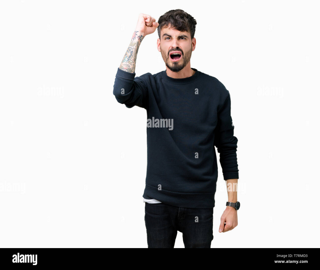 Young handsome man over isolated background angry and mad raising fist ...