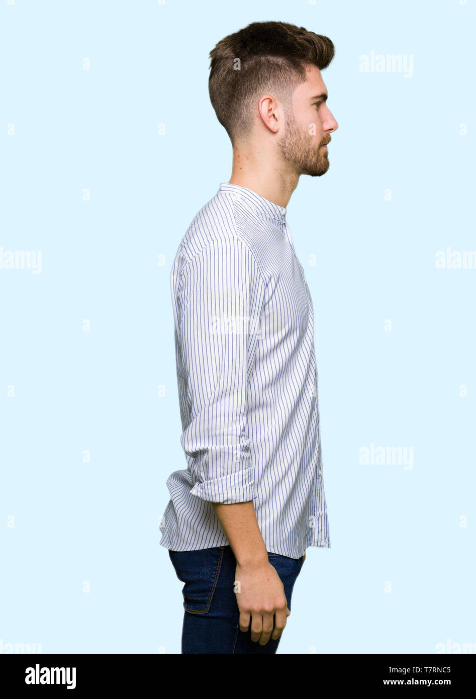 Young handsome man looking to side, relax profile pose with natural ...