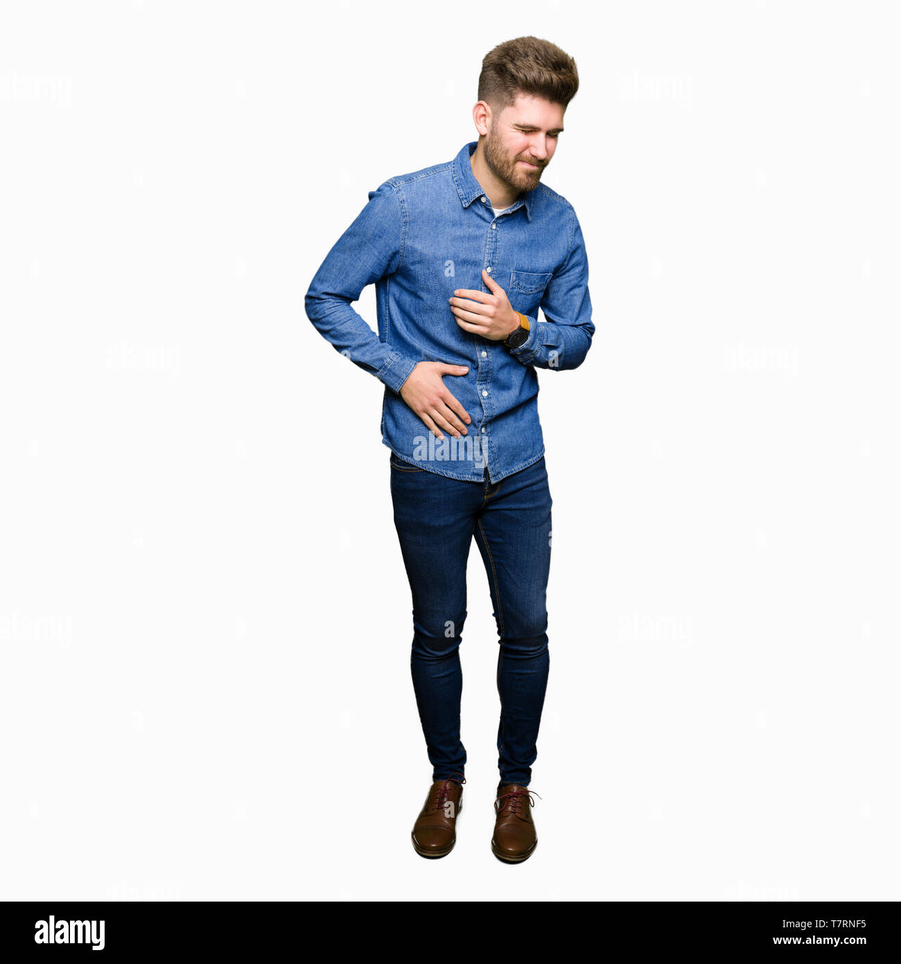 Young handsome blond man wearing casual denim shirt with hand on ...