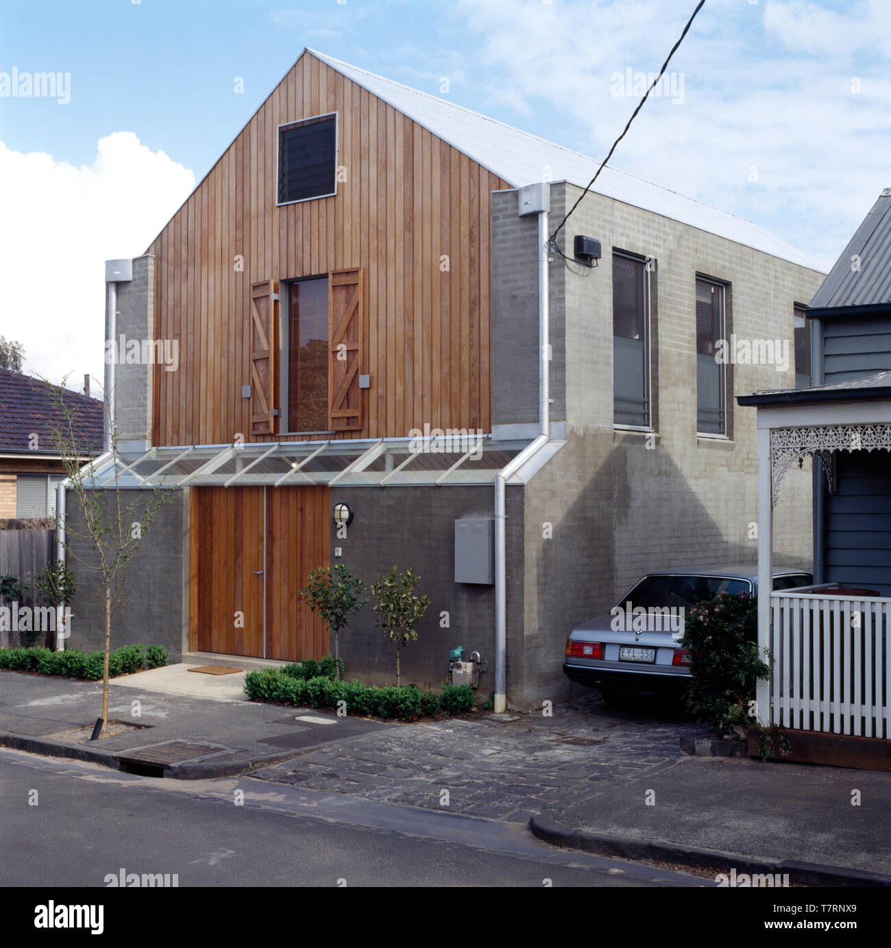 Wooden cladding on the front elevation of a modern grey house Stock ...