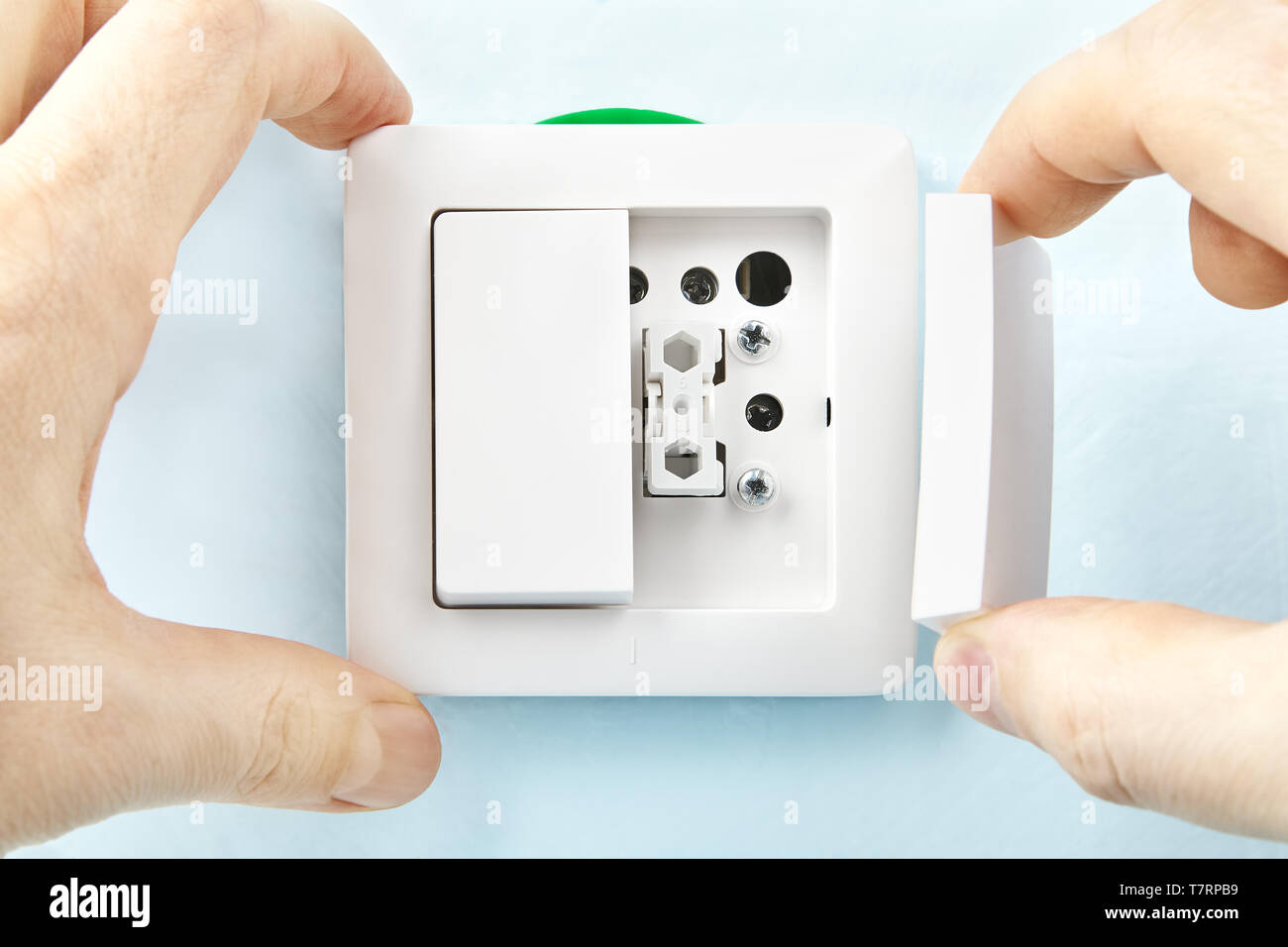 Worker is mounting new european standard push button making new buttons ...