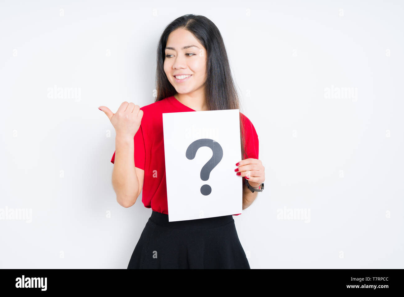Young brunette woman holding paper with question mark over isolated ...