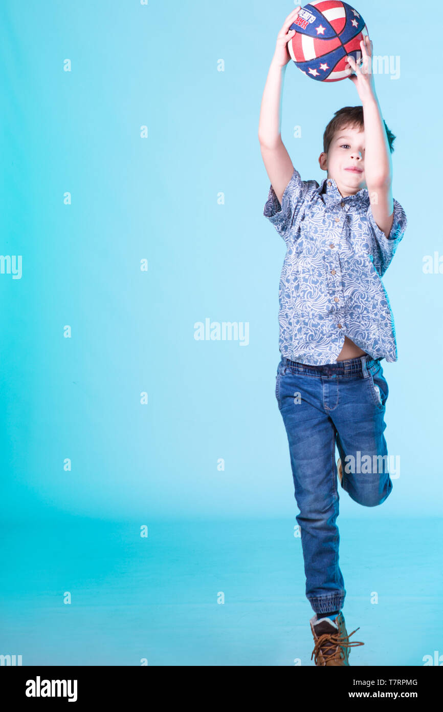 12 year old boy jumping to throw / catch basketball Stock Photo - Alamy