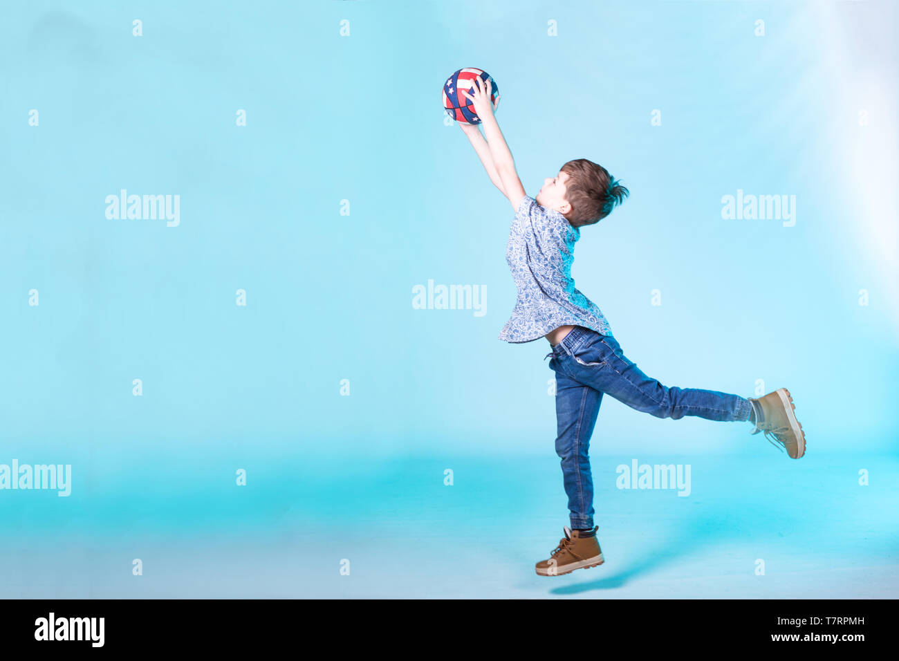 12 year old boy jumping to throw / catch basketball Stock Photo - Alamy
