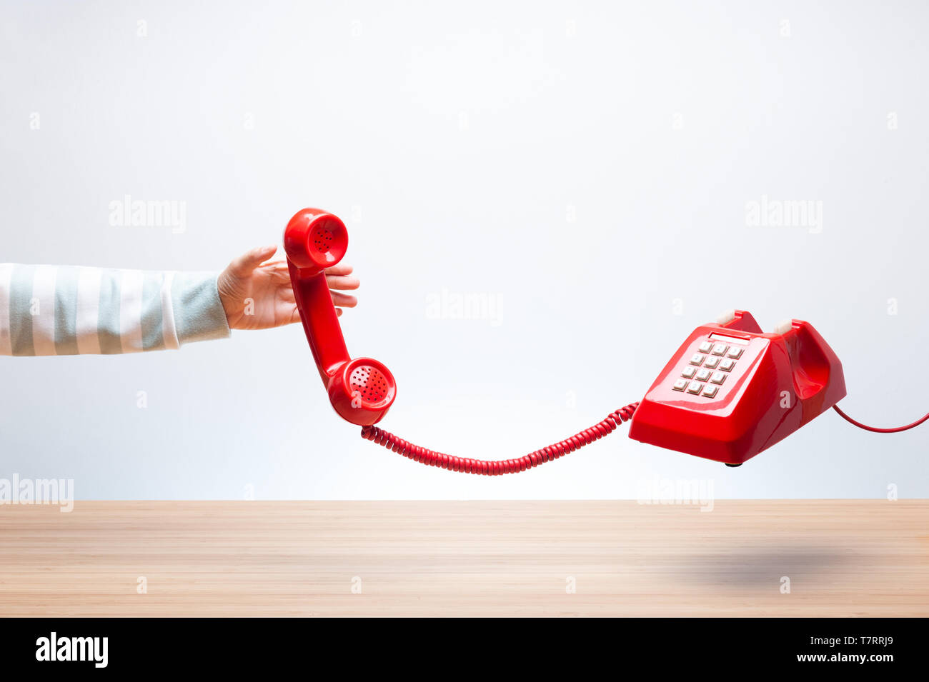 Woman reaching the red phone, urgent call waiting , classic red ...