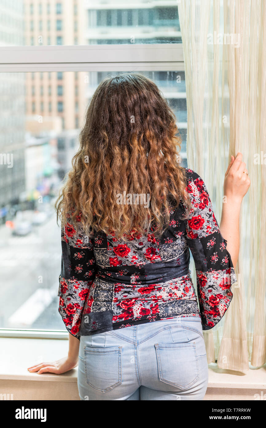 Office buildings glass window of young woman girl standing looking ...