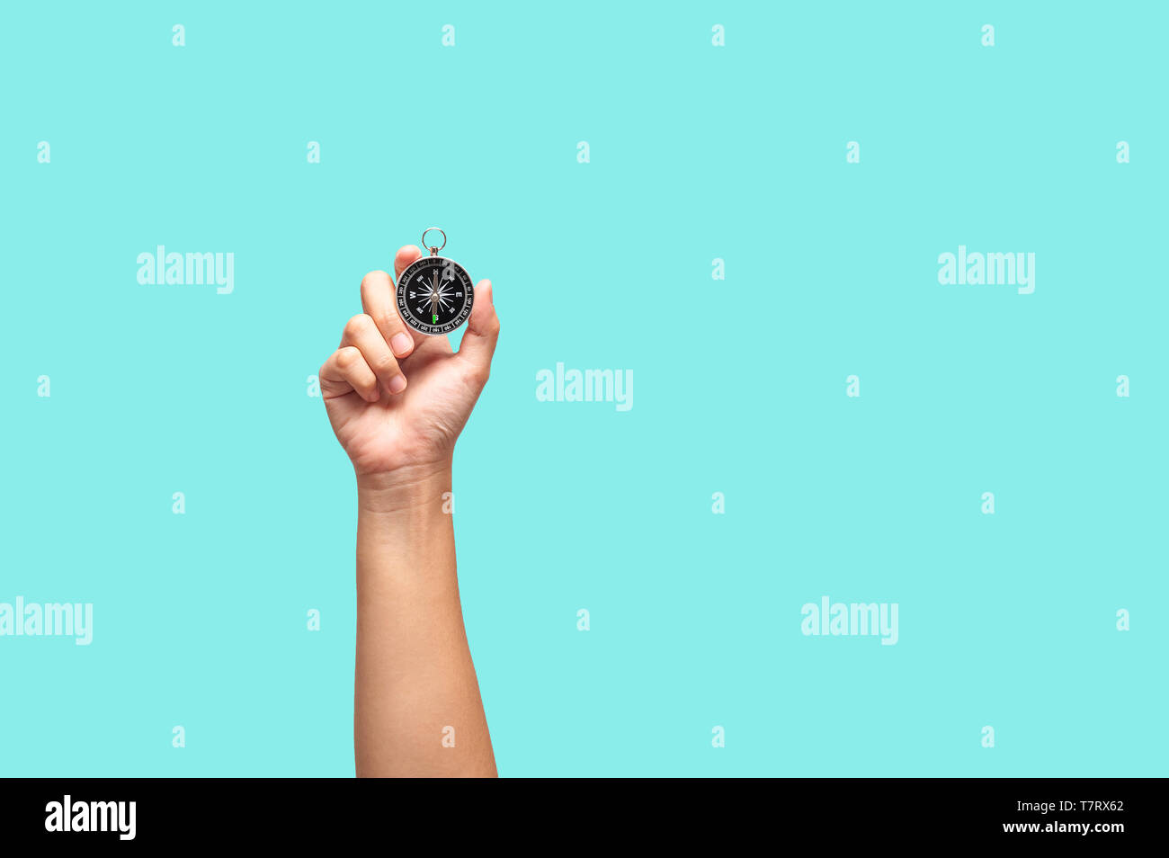 Hand holding compass in one hand on white background, searching ...