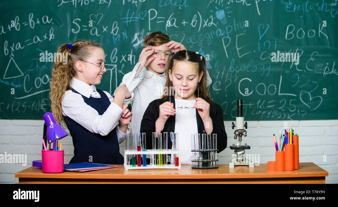 Happy children friendship. Teamwork. students doing science experiments ...