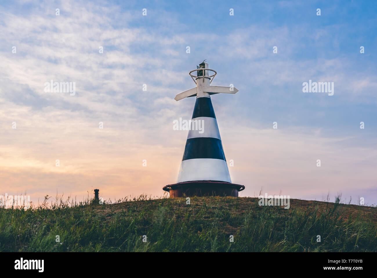 Beacon with the pointer on the hill in sunset light Stock Photo - Alamy