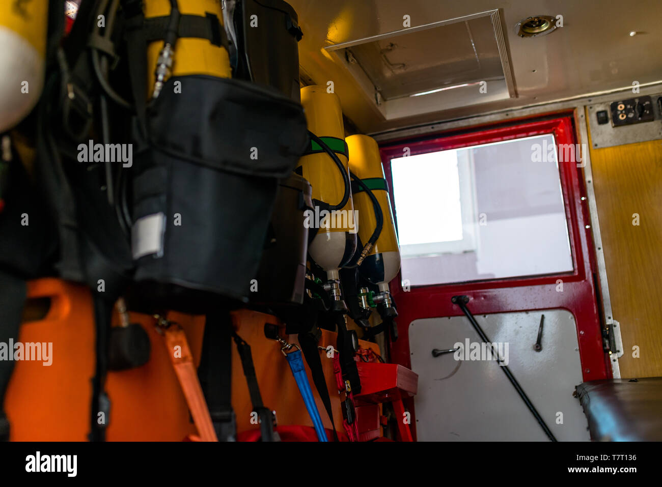Yellow oxygen cylinders for firefighters, placed in an old fire truck ...
