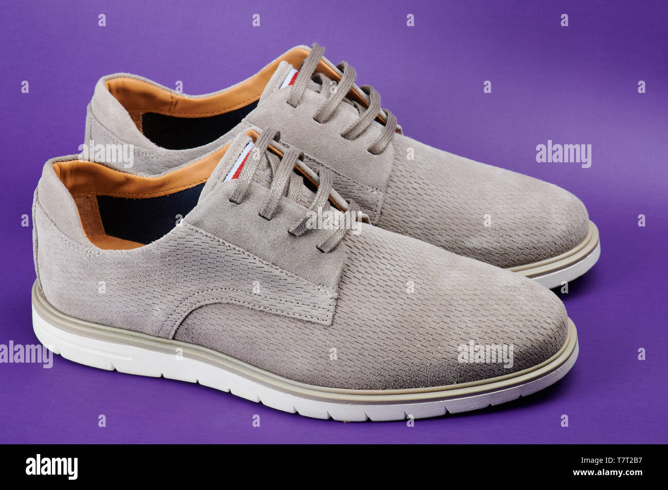 Elegant casual man pair shoes side view isolated on purple background ...