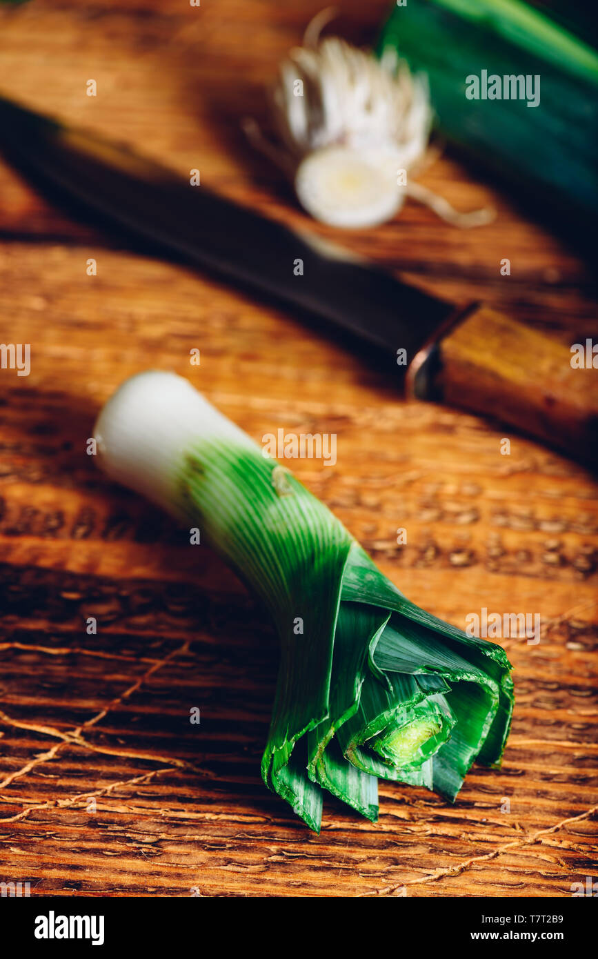 Fresh green leek on rustic wooden table Stock Photo - Alamy