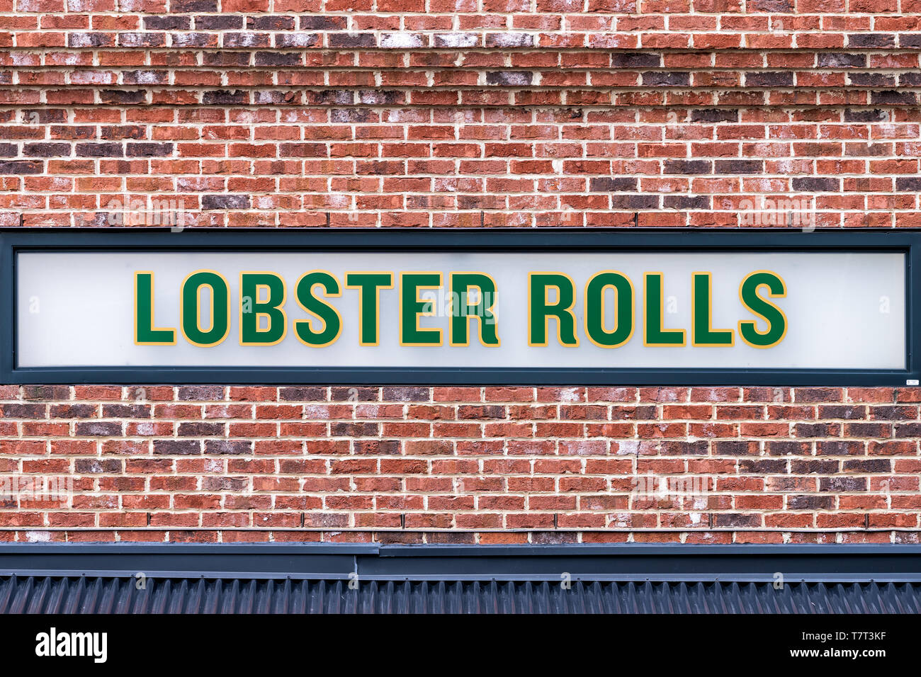 Closeup of generic lobster rolls sign on restaurant brick architecture ...