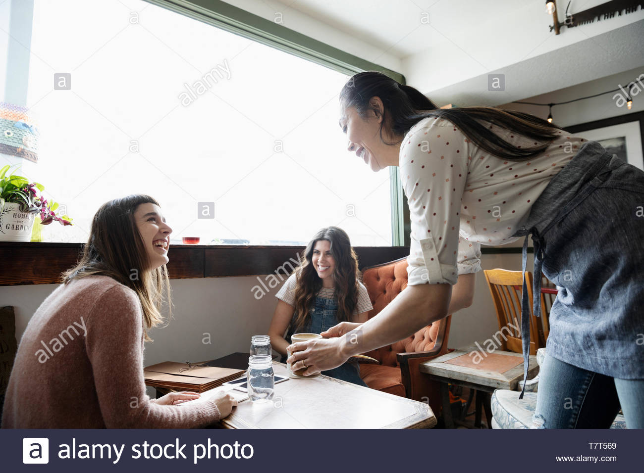 Waitress standing in a cafe hi-res stock photography and images - Alamy