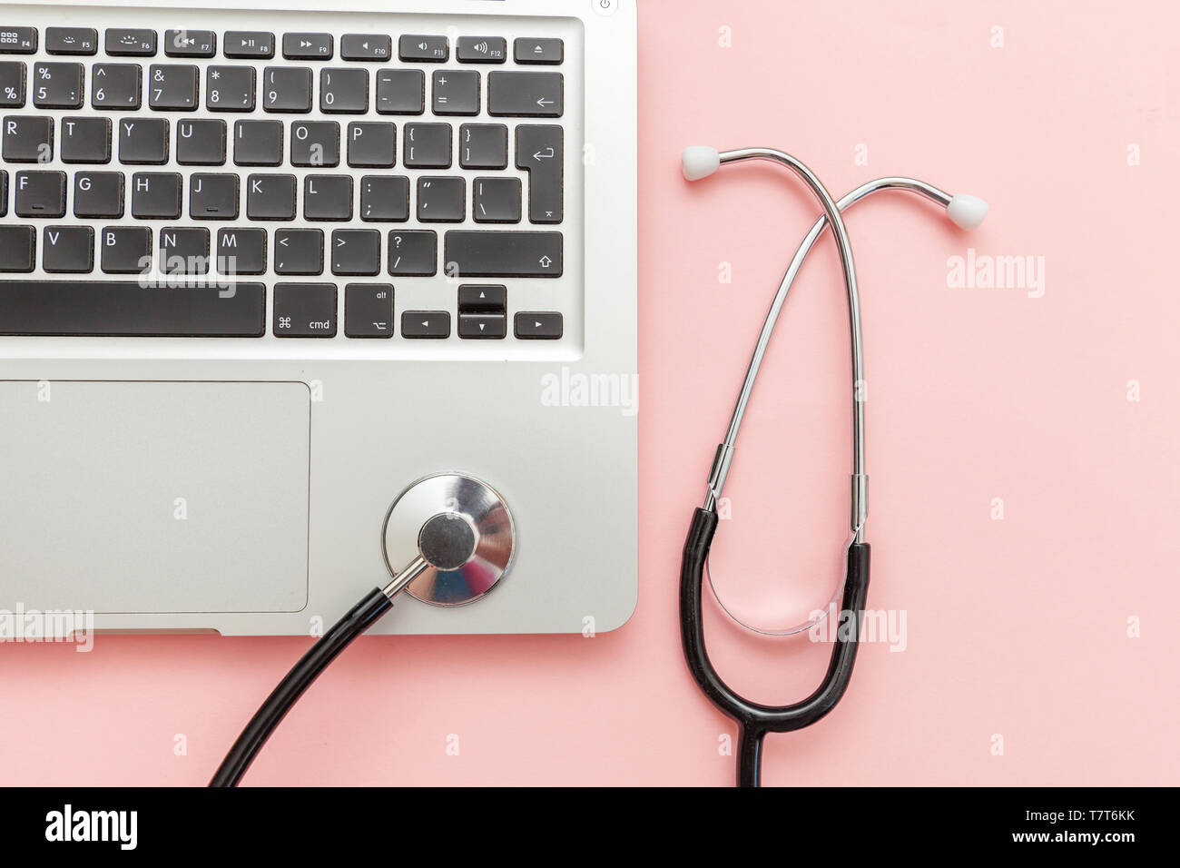 Stethoscope keyboard laptop computer isolated on pink background ...