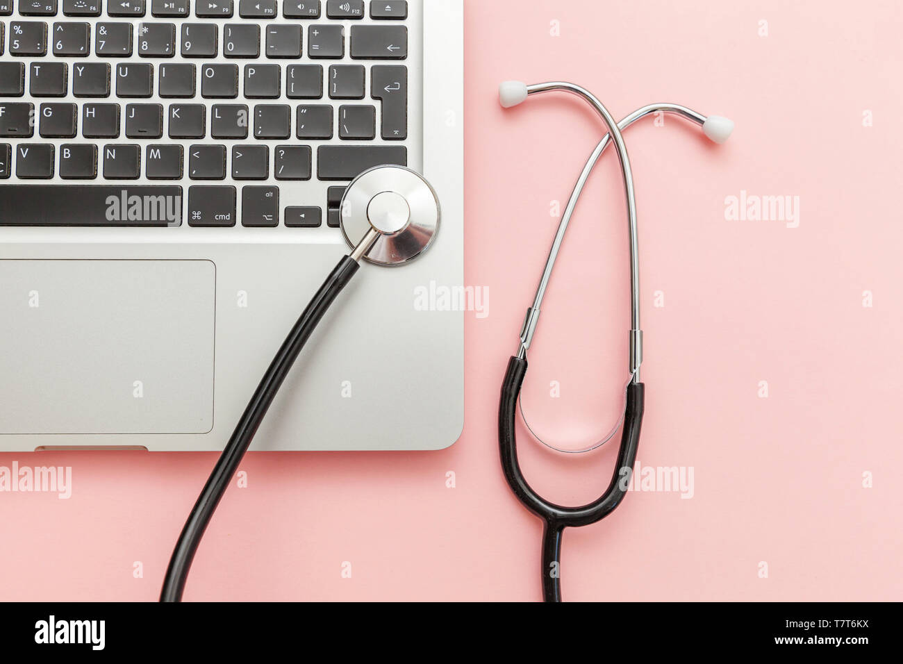 Stethoscope keyboard laptop computer isolated on pink background ...
