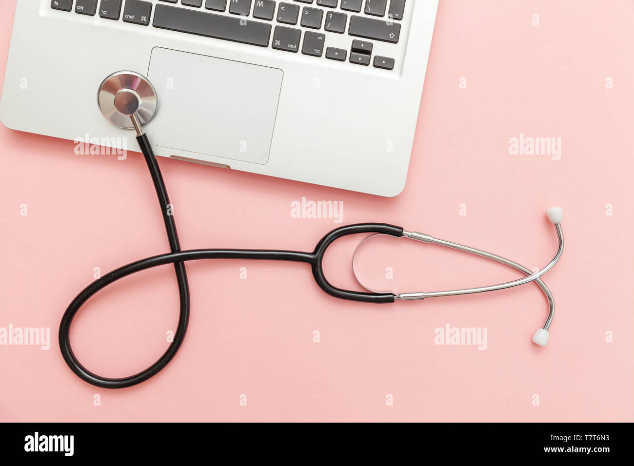 Stethoscope keyboard laptop computer isolated on pink background ...