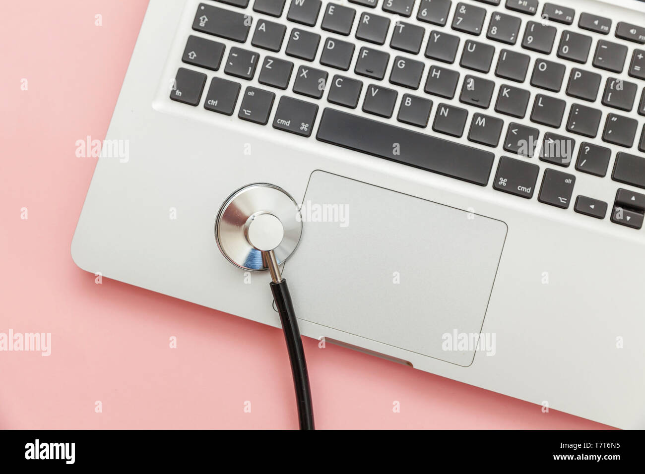 Stethoscope keyboard laptop computer isolated on pink background ...