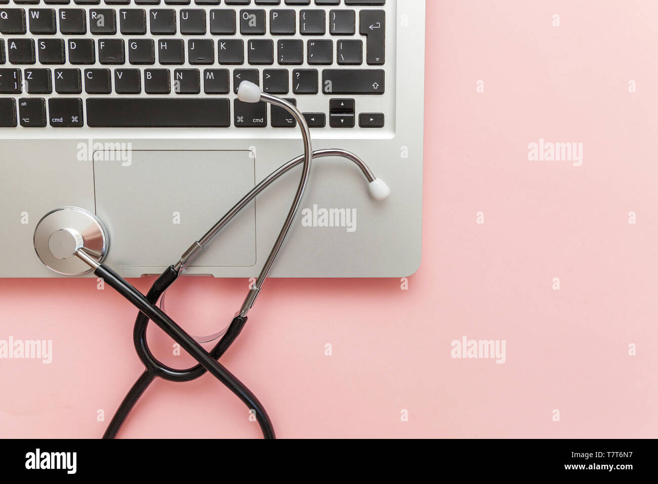 Stethoscope keyboard laptop computer isolated on pink background ...