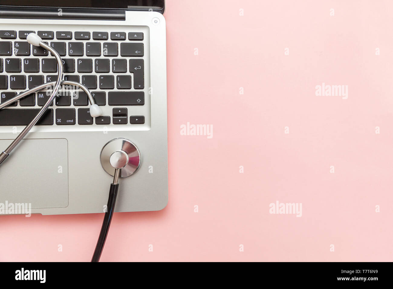 Stethoscope keyboard laptop computer isolated on pink background ...
