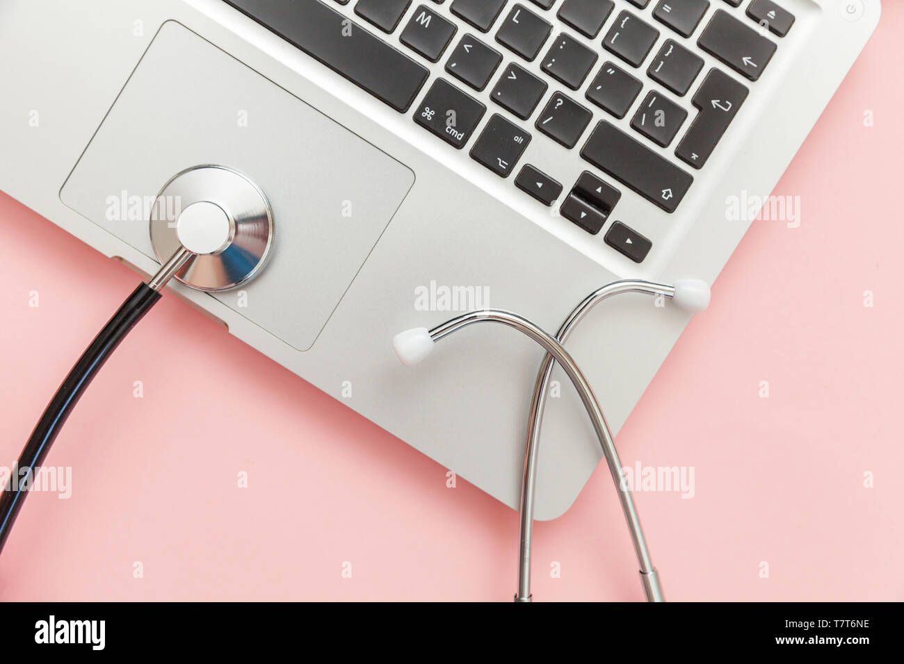 Stethoscope keyboard laptop computer isolated on pink background ...