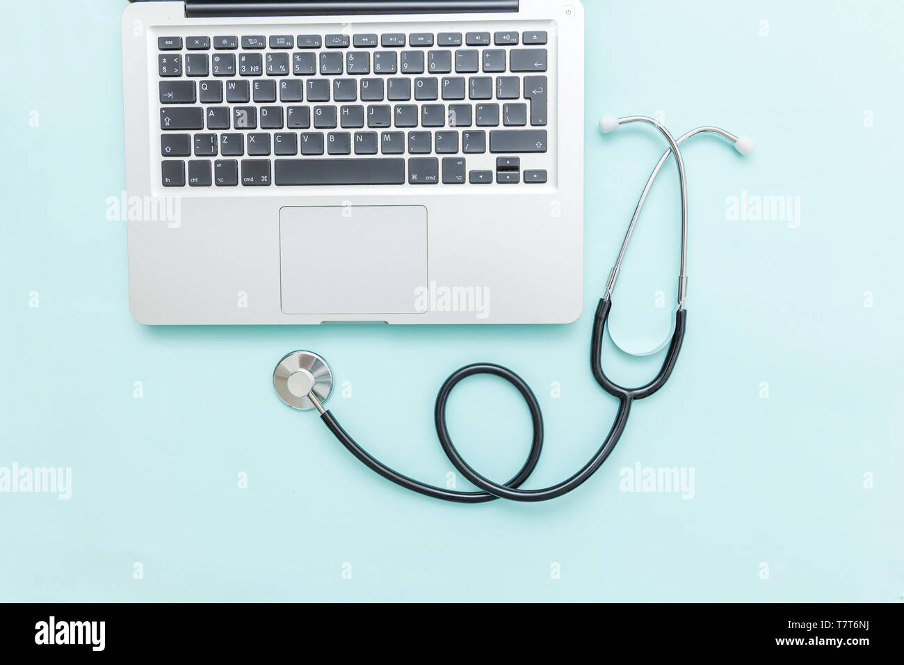 Stethoscope keyboard laptop computer isolated on blue background ...