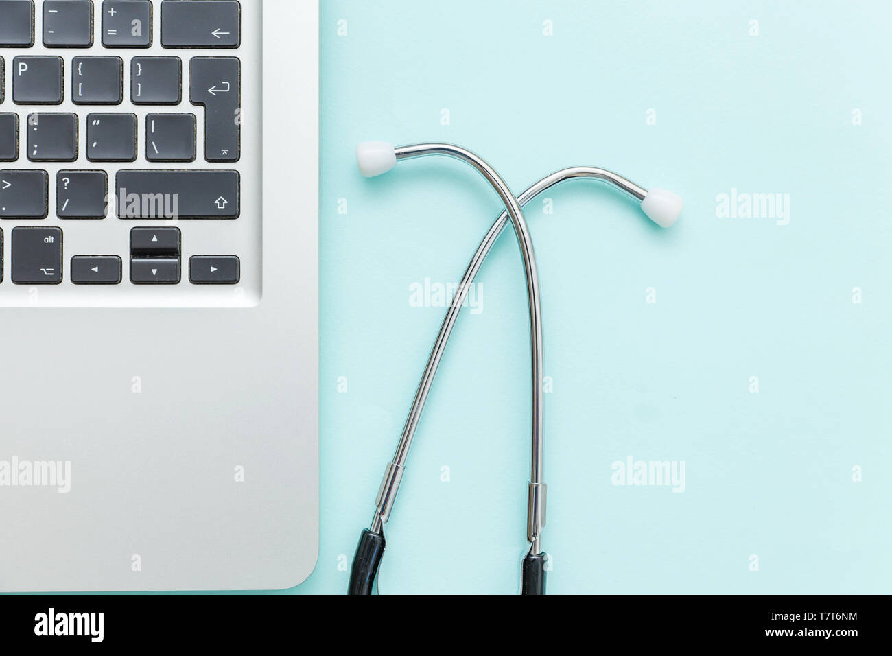 Stethoscope keyboard laptop computer isolated on blue background ...