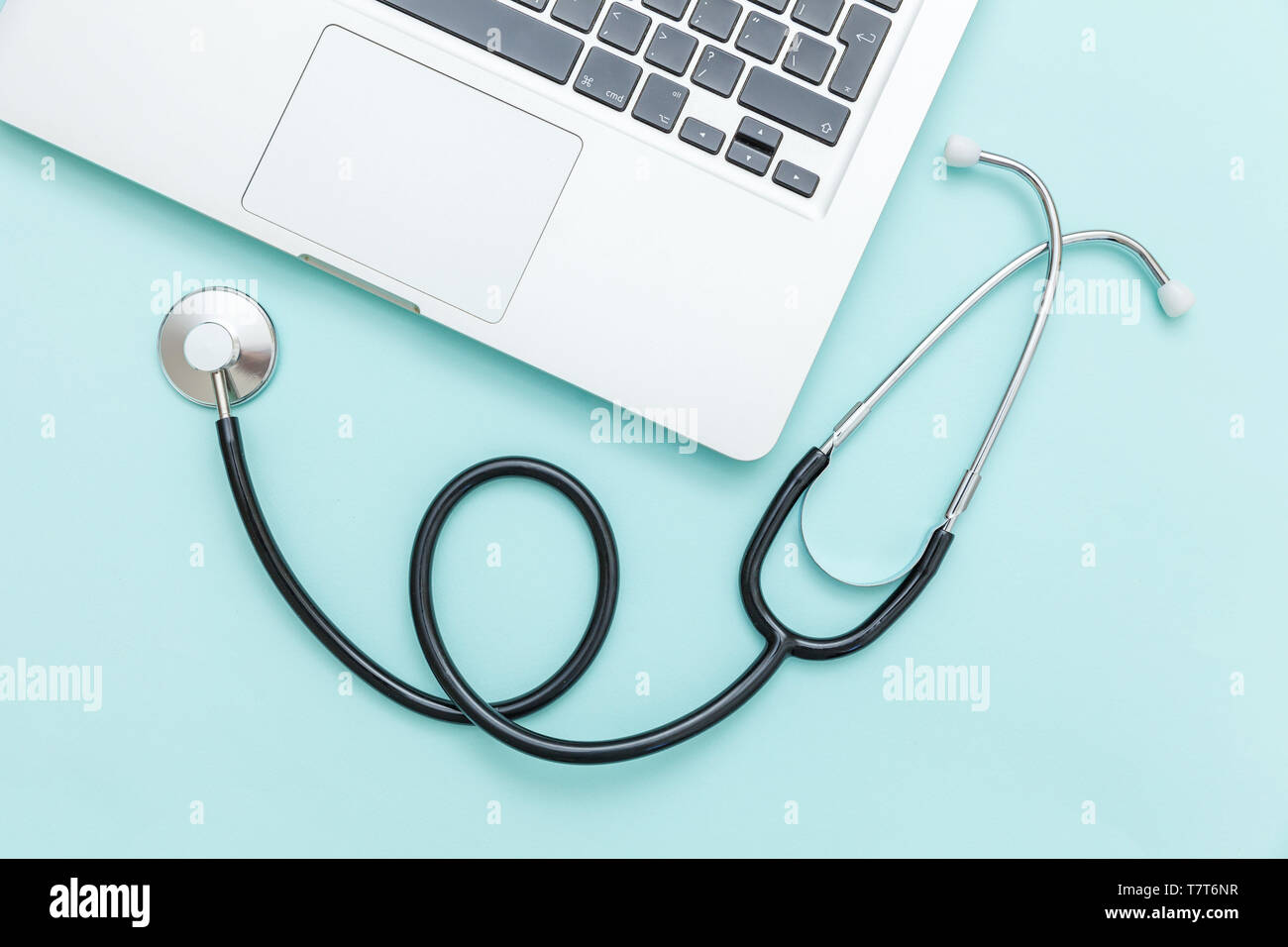 Stethoscope keyboard laptop computer isolated on blue background ...