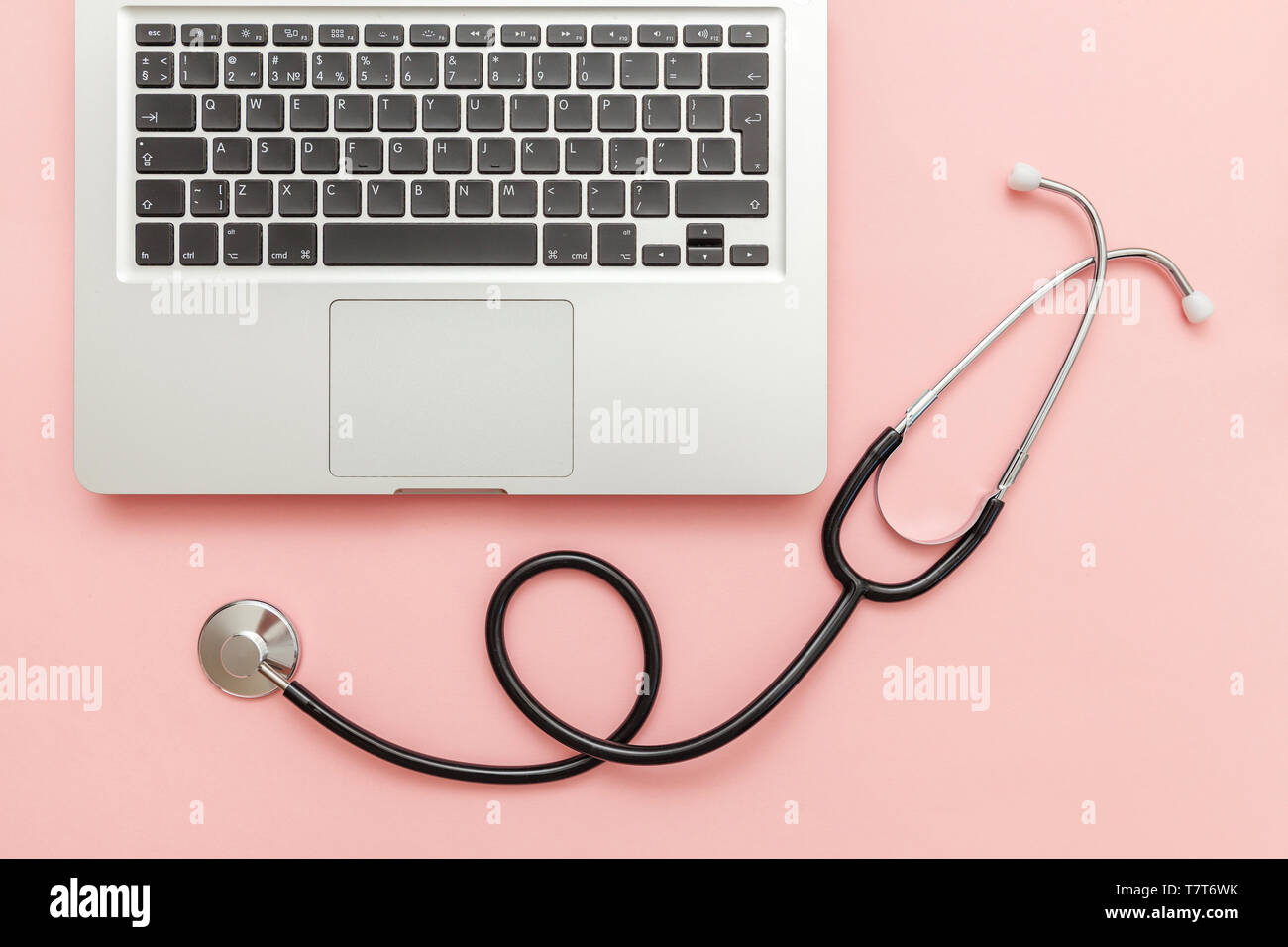 Stethoscope keyboard laptop computer isolated on pink background ...