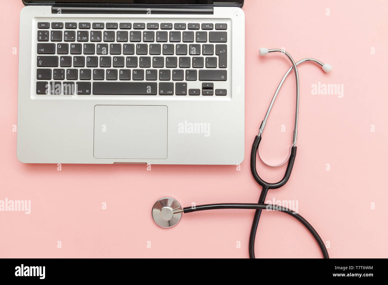 Stethoscope keyboard laptop computer isolated on pink background ...